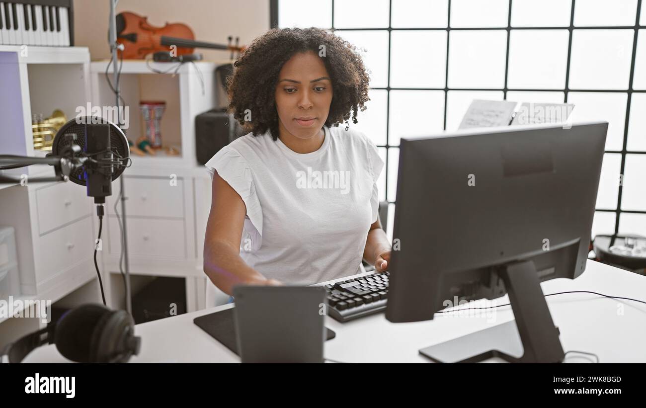 African american woman producing music in a home studio Stock Photo - Alamy