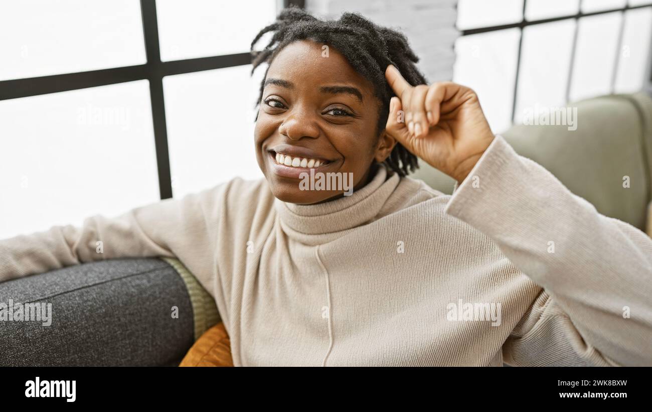 Smiling african american woman with dreadlocks making a eureka gesture ...