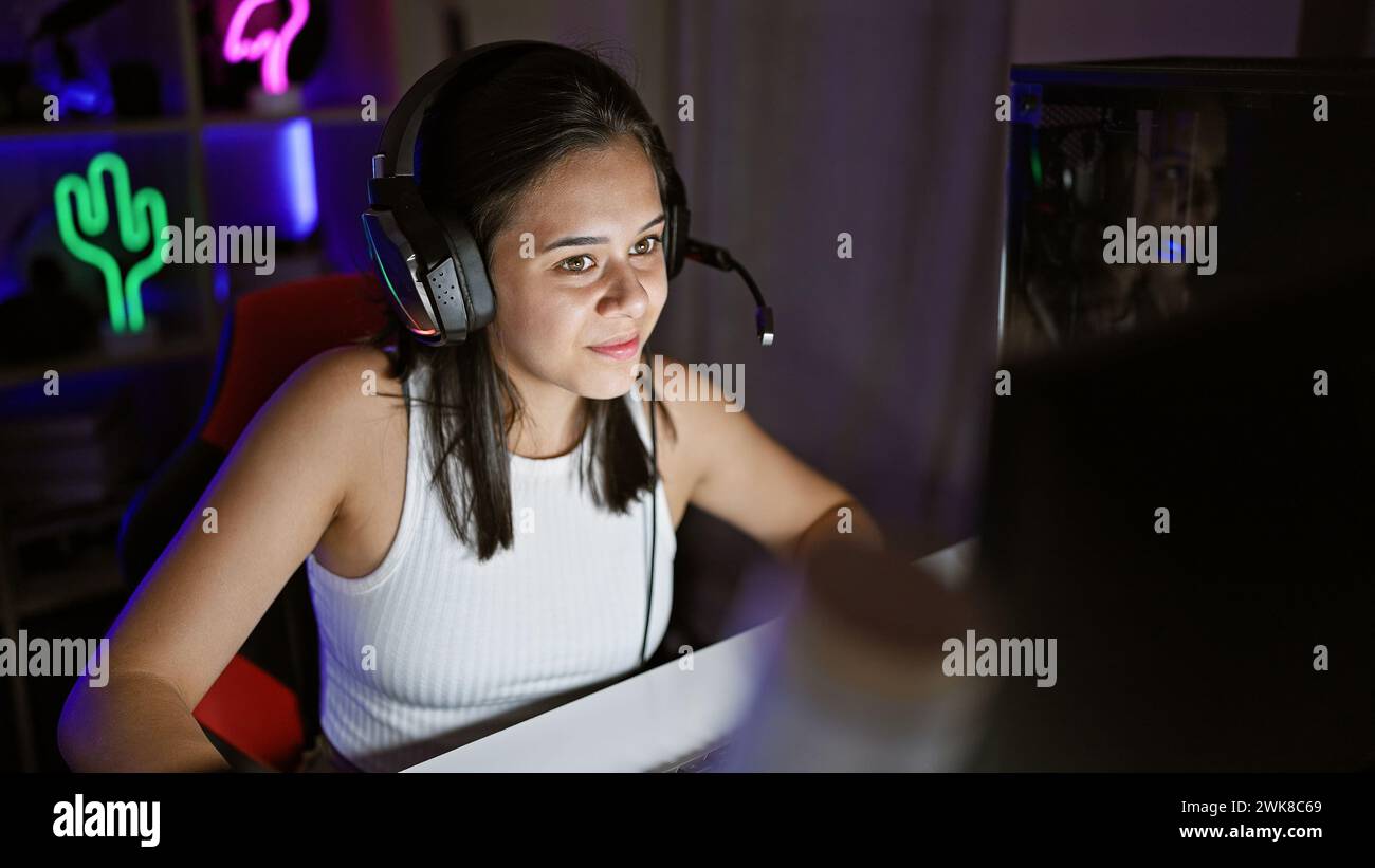 Young beautiful hispanic woman streamer playing video game using ...