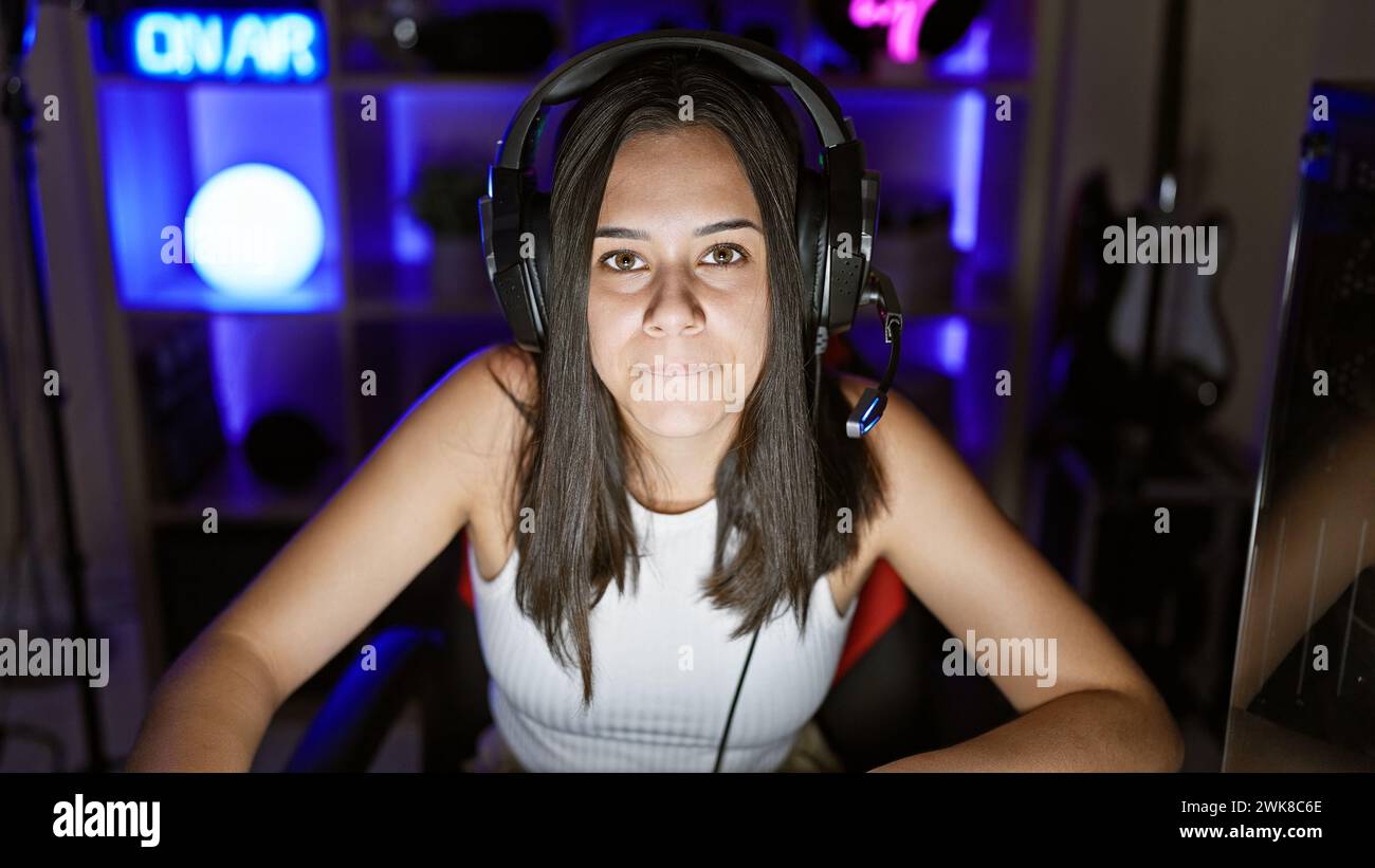 Young beautiful hispanic woman streamer playing video game using ...