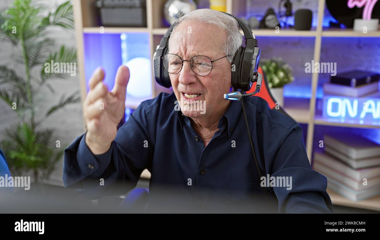 Upset senior man streamer looking stressed while playing video game in ...