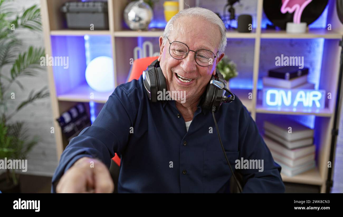 Cheerful senior man streamer, beaming with a big smile, engaged in his ...