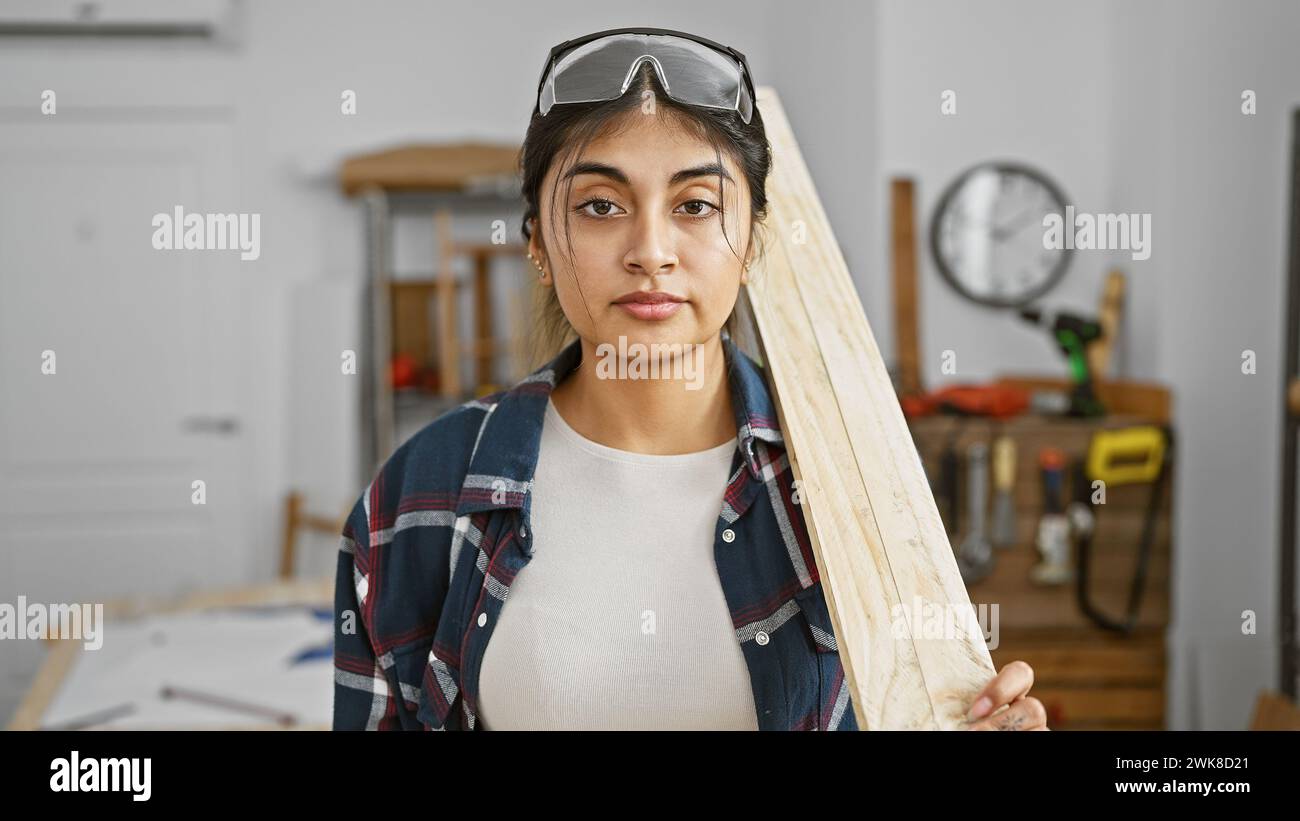 South asian woman with long hair wearing safety glasses in a ...