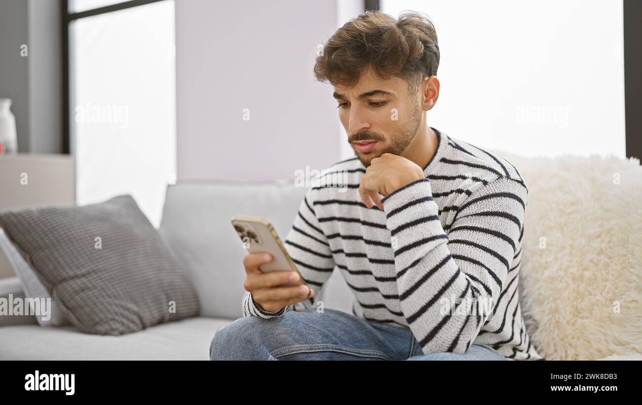 Serious young arab man doubting his next idea, deeply immersed while ...