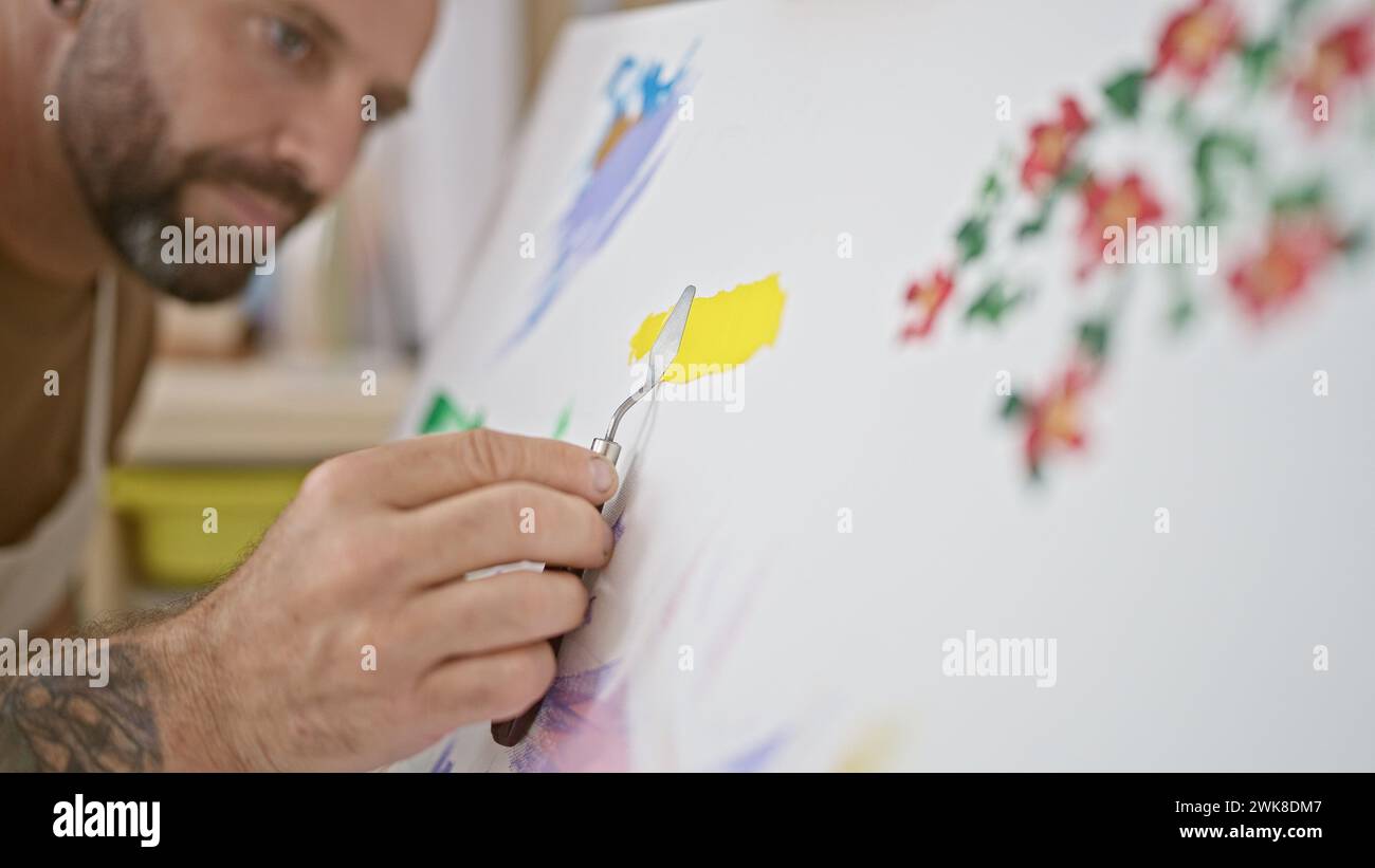 Handsome young man, artistic soul unleashed, drawing with spatula in ...