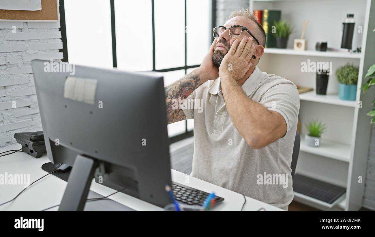 Stressed-out young business worker man feeling the heat of stress and ...