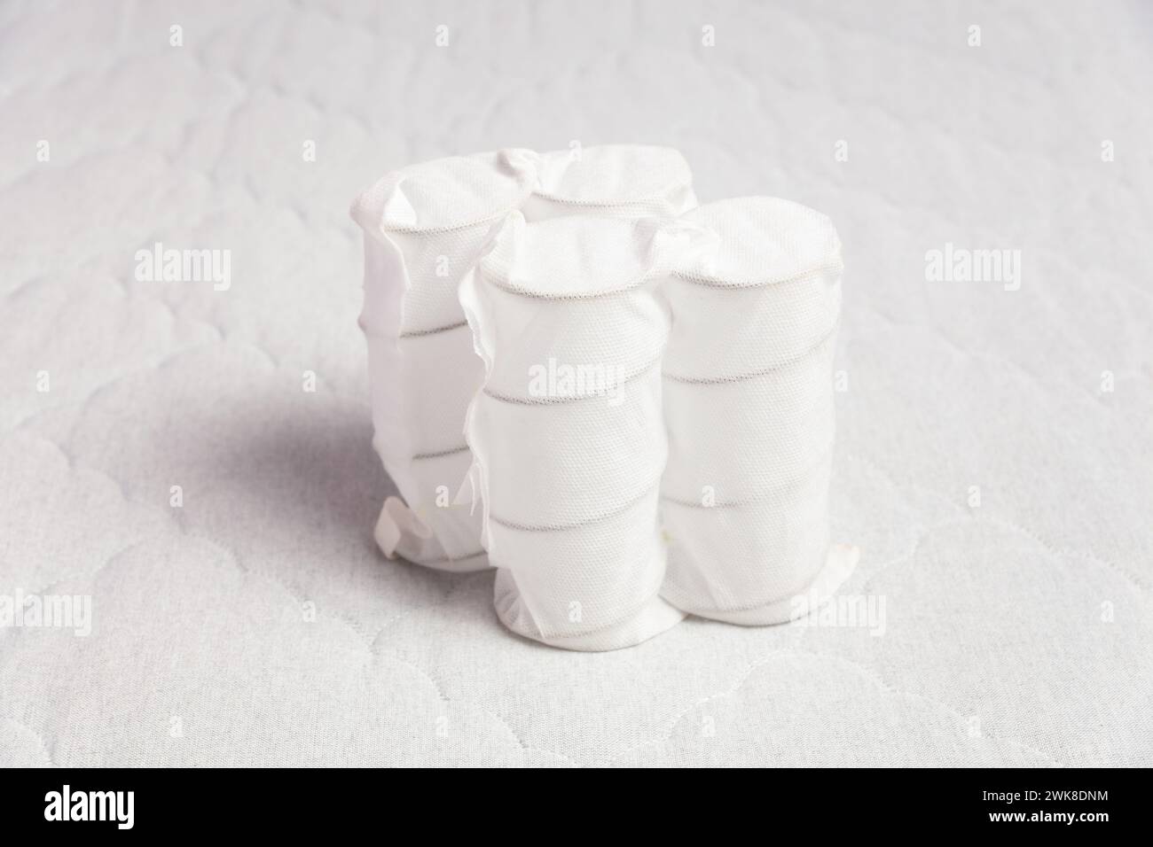 Independent spring block packed in white spunbond. Bonding layers of ...