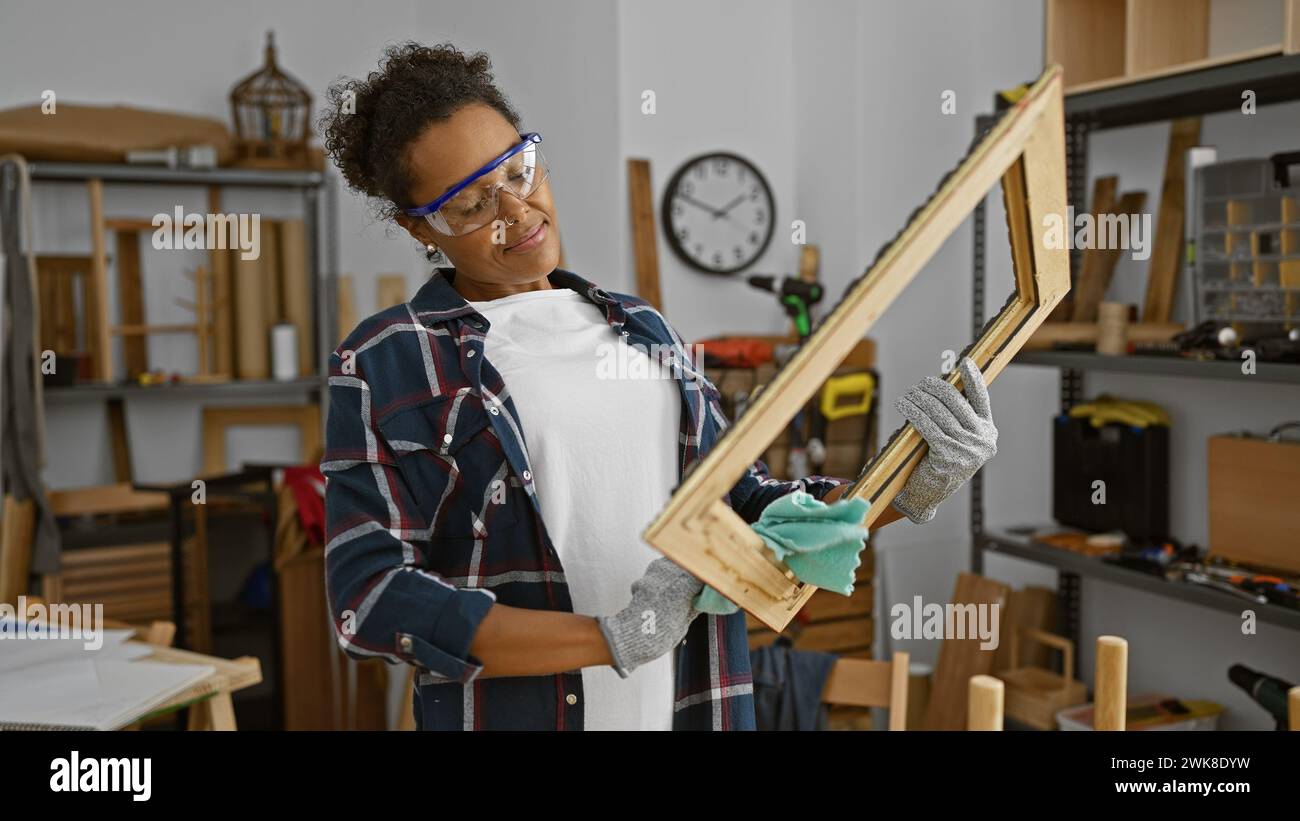 Adult african american woman working in a woodshop studio, examining a ...