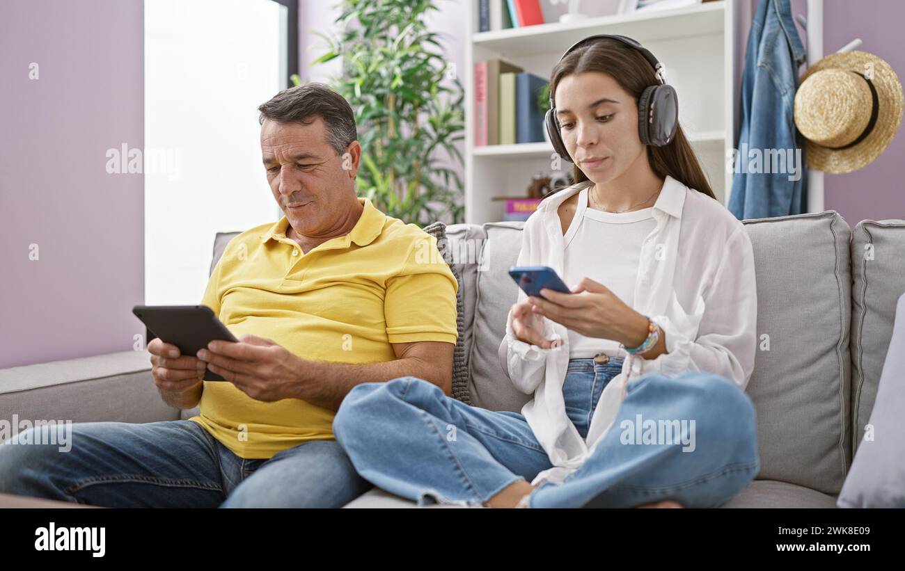At home, a loving father and his daughter relaxing on a comfortable ...