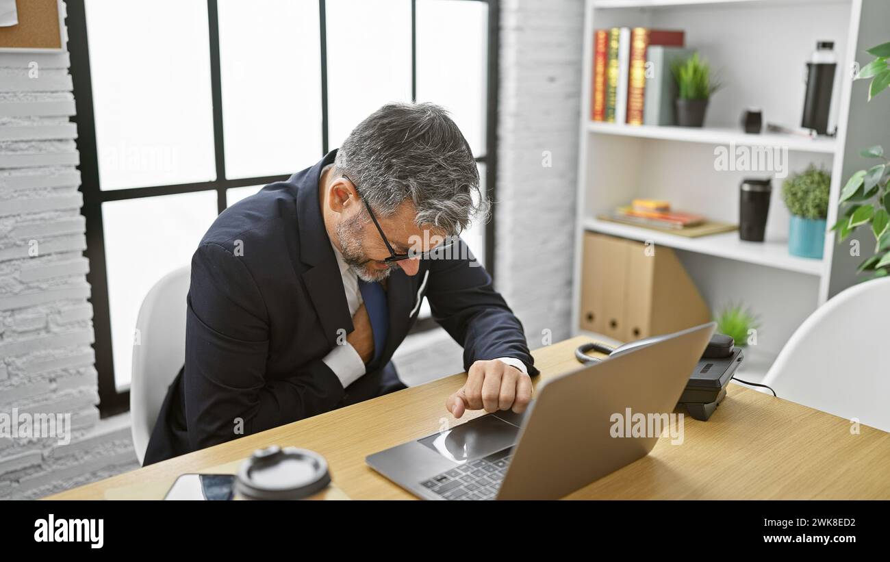 Heart attack strikes young grey-haired hispanic office worker - high ...