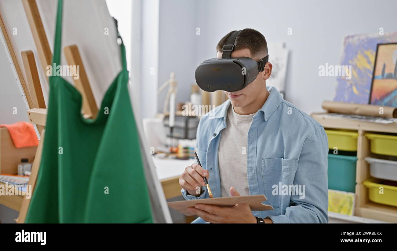 A young man uses virtual reality in a modern art studio, showcasing ...