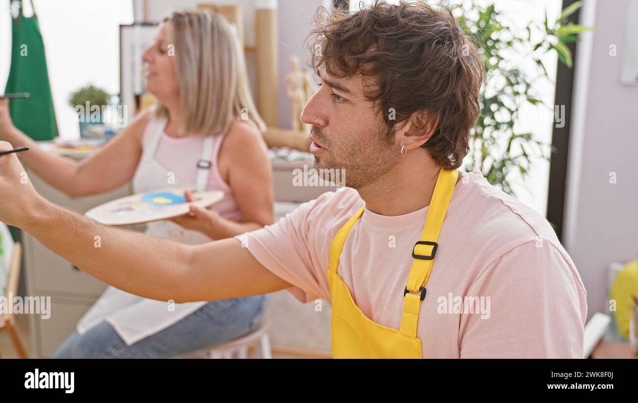 In the heart of creativity, two confident artists, man and woman ...