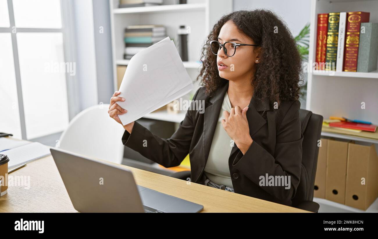 Gorgeous young hispanic office pro working hard, making paperwork hand ...