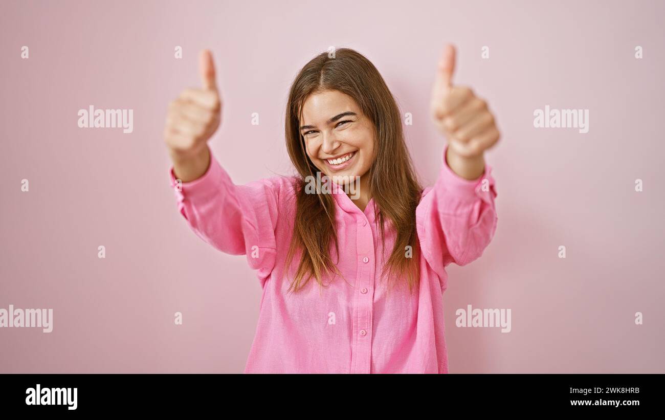Radiant young hispanic woman flashing you a thumbs up gesture ...
