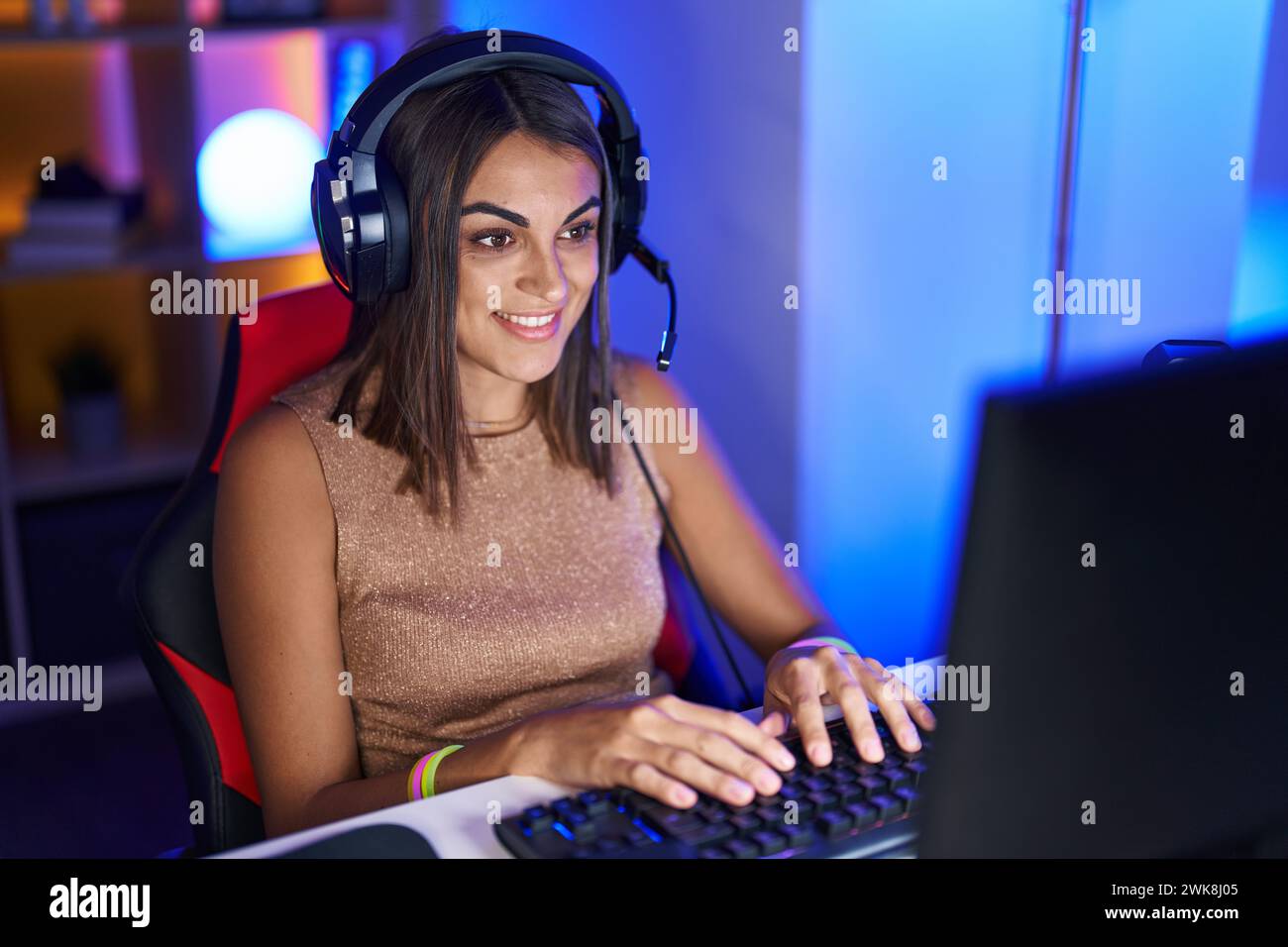 Young beautiful hispanic woman streamer playing video game using ...