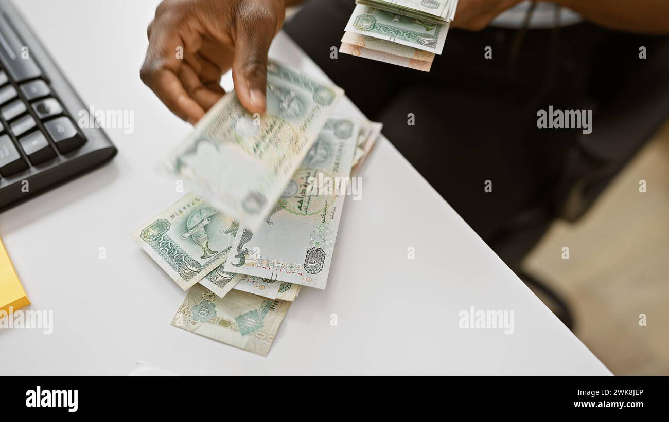 African woman counting uae dirhams in a modern office setting ...
