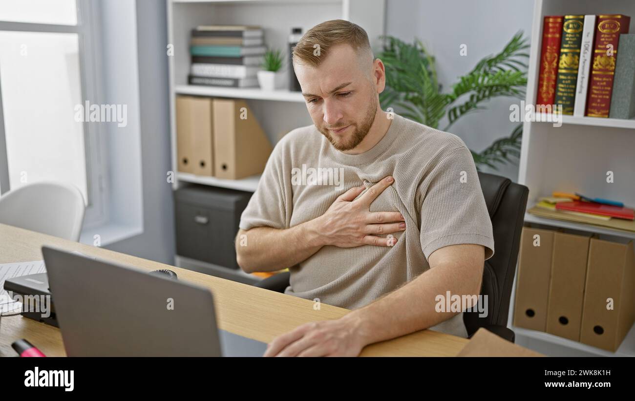 Young caucasian man experiencing chest pain while working at his office ...
