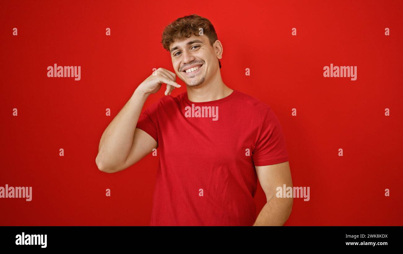 Confident young hispanic man, joyfully smiling over a laid-back phone ...
