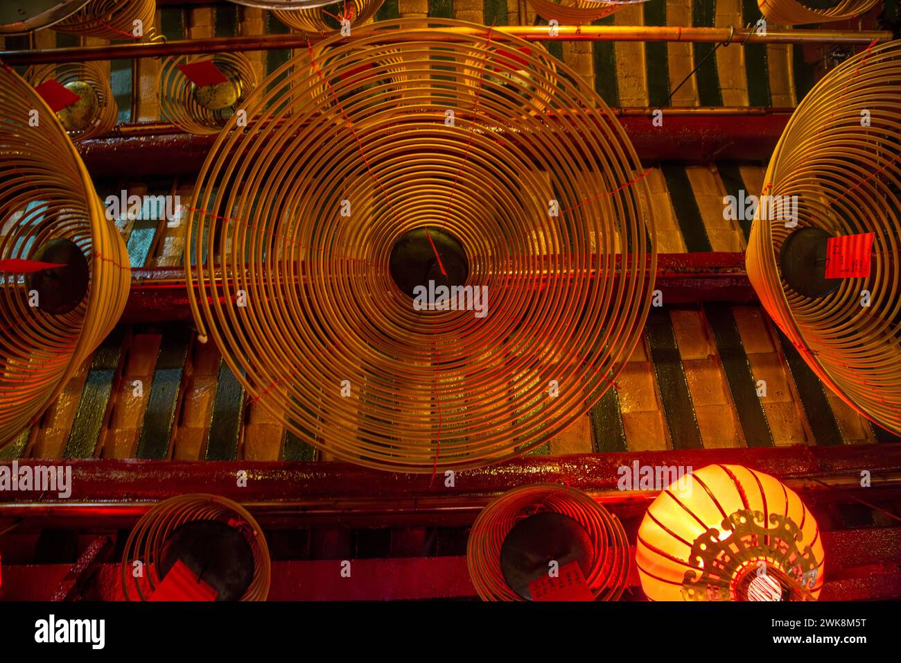Burning incense coils send prayers to heaven in the Man Mo Temple, a ...
