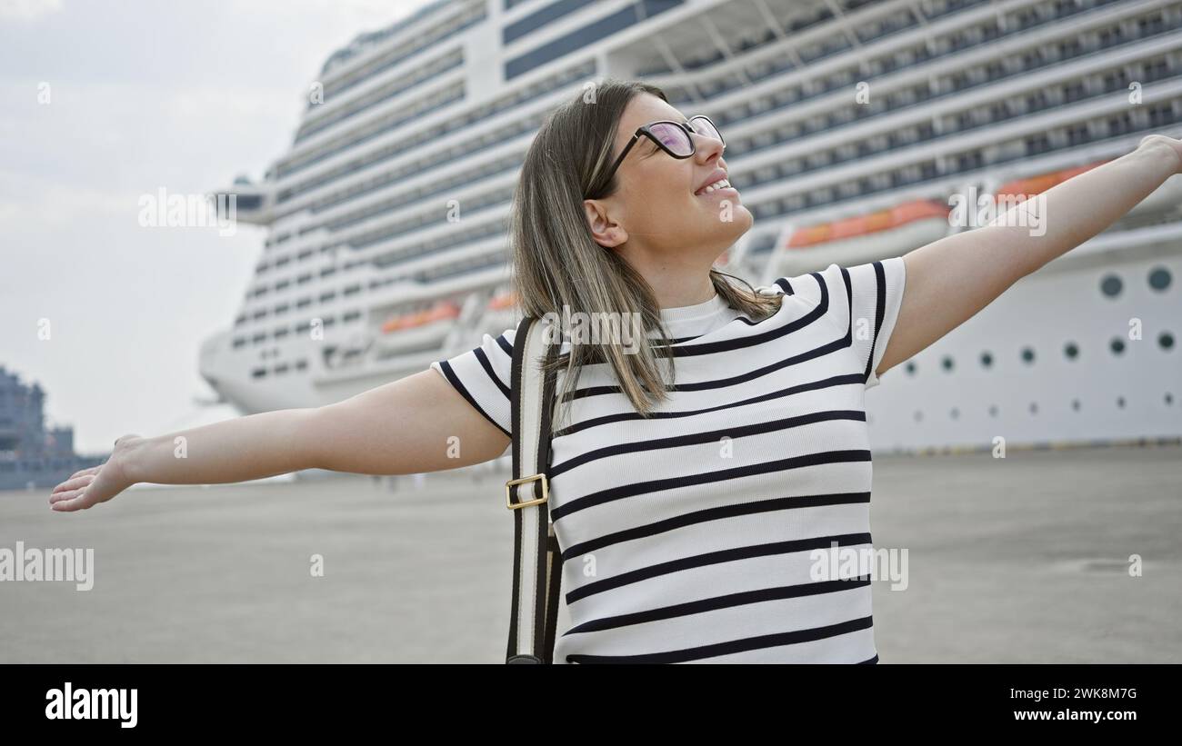Joyful woman embracing freedom in front of a cruise ship on a sea ...