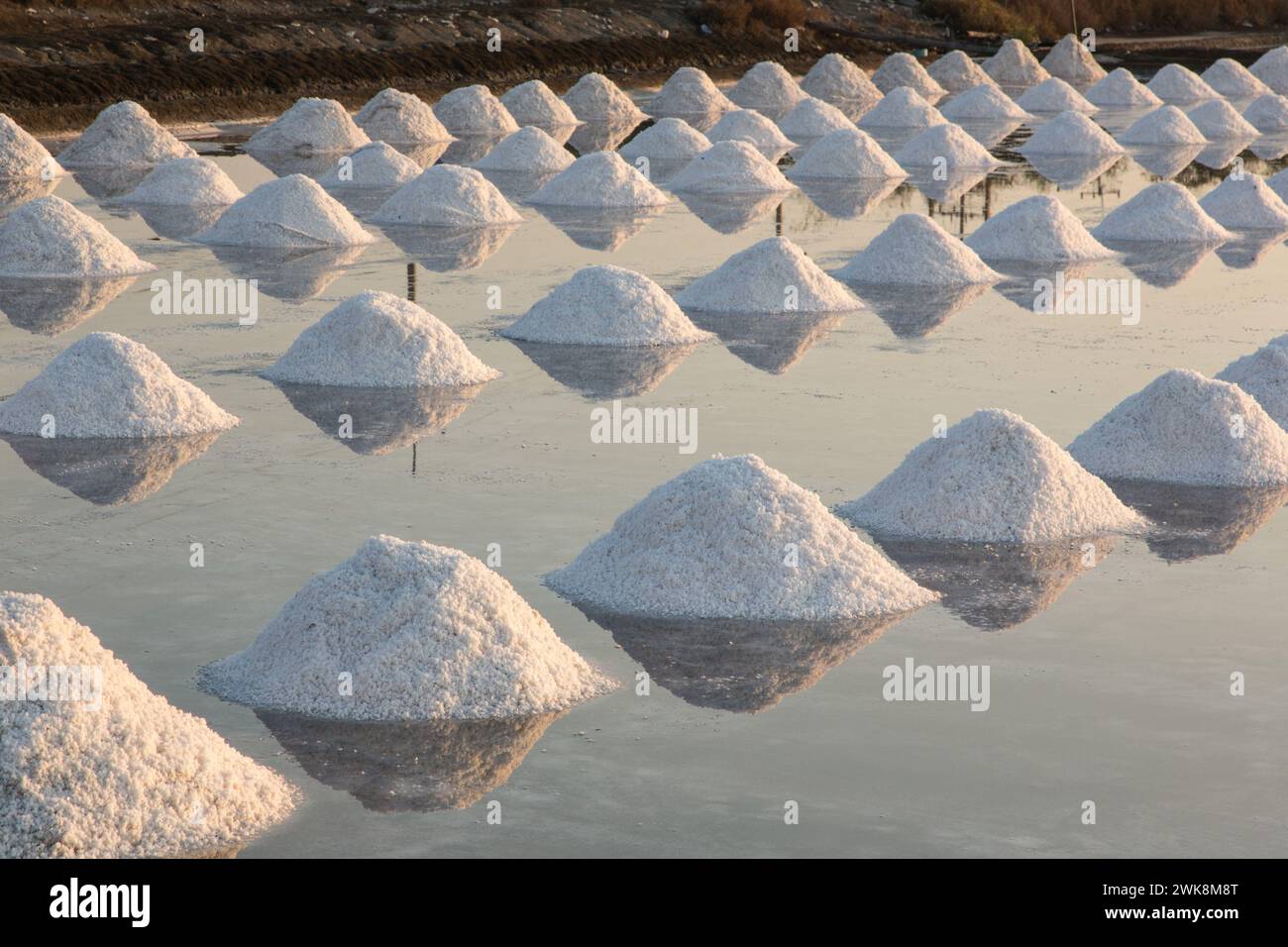 Piles of salt create geometric designs on the salt pan at a traditional ...