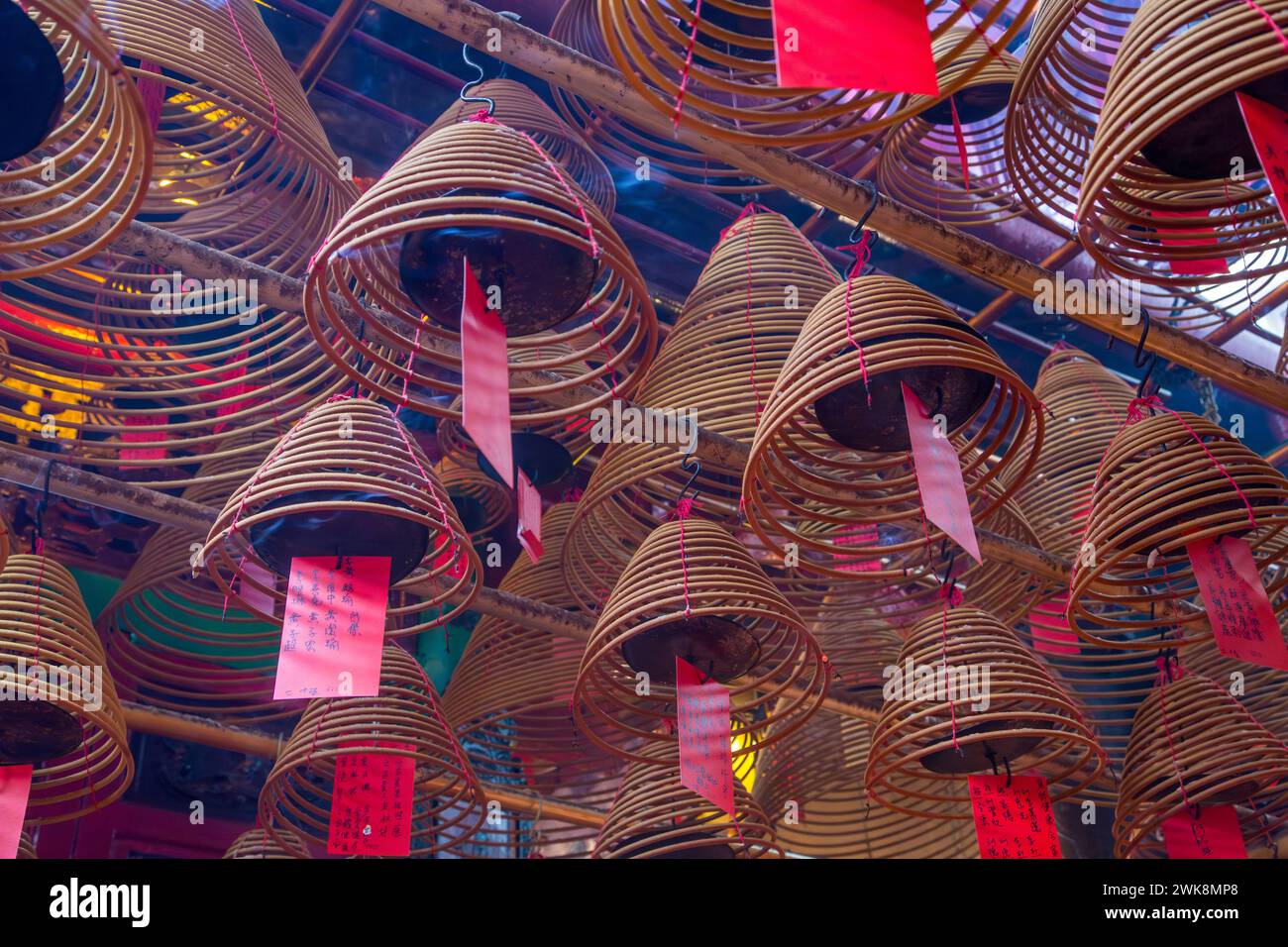 Burning incense coils send prayers to heaven in the Man Mo Temple, a ...