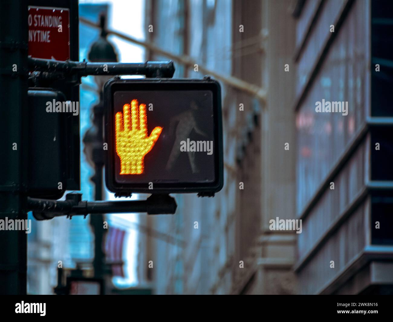 Street sign depicting pedestrian walk and stop signals alongside an ...
