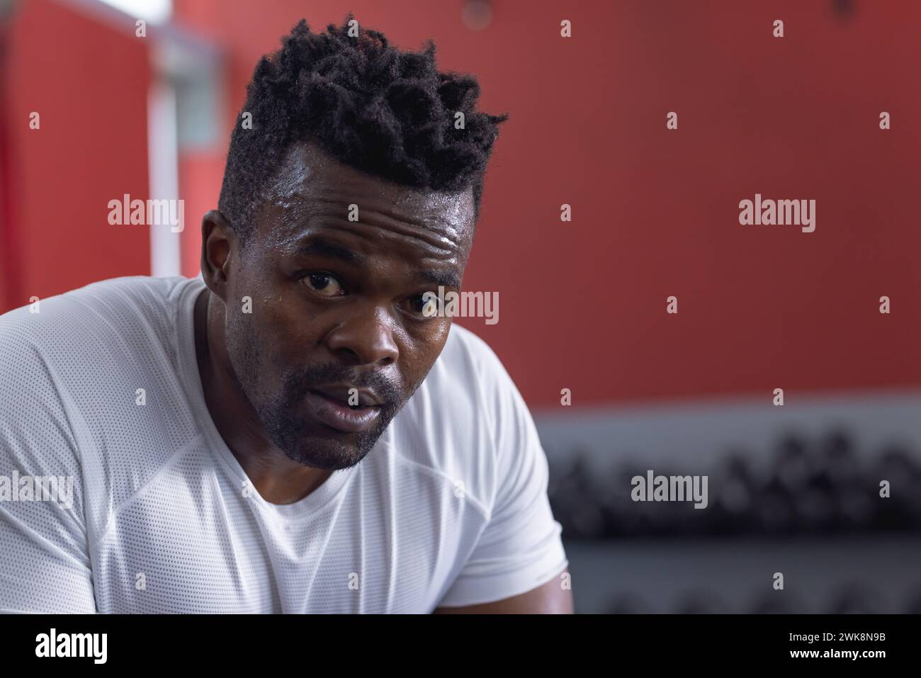 Fit African American man takes a break at the gym Stock Photo - Alamy