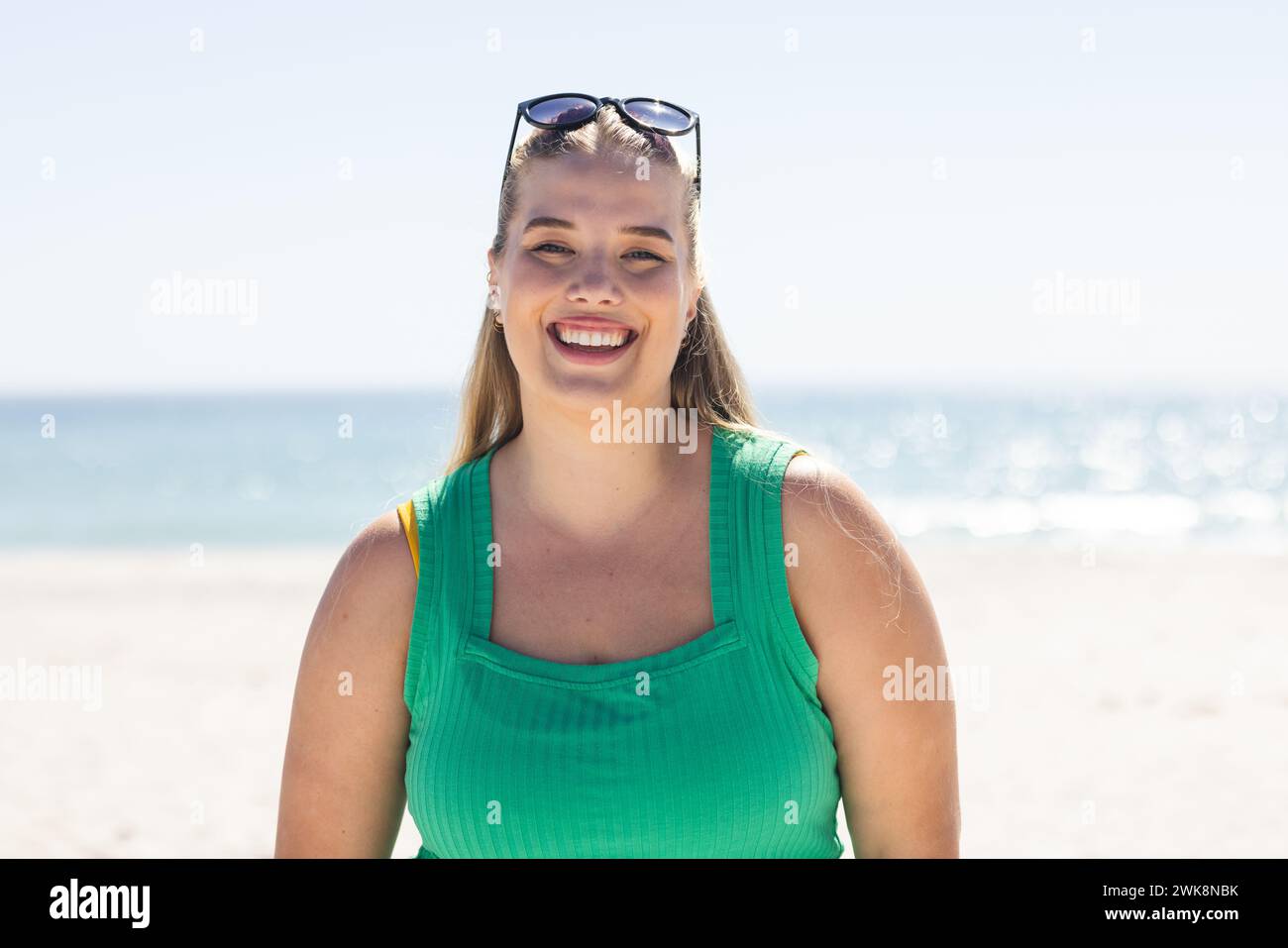Young plus size Caucasian woman smiles brightly at the beach Stock ...