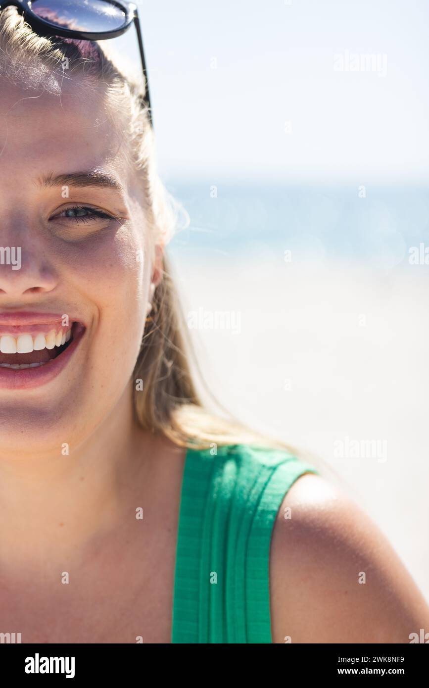 A young plus size Caucasian woman smiles brightly at the beach, with ...