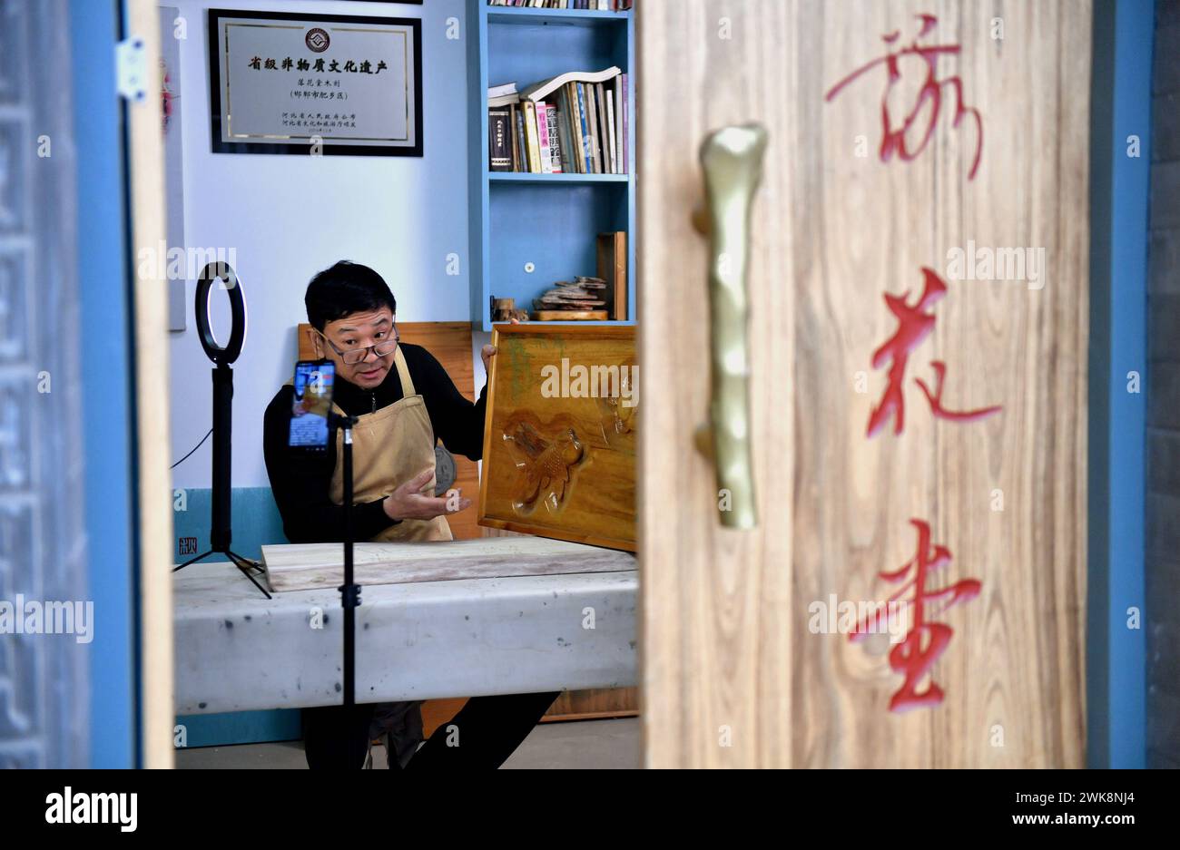Handan, China's Hebei Province. 19th Feb, 2024. Craftsman Cui Jianjun presents his wood carvings ...
