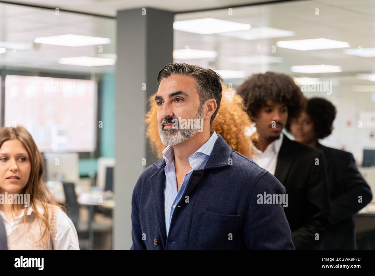 Confident male professional leading a group discussion with diverse ...
