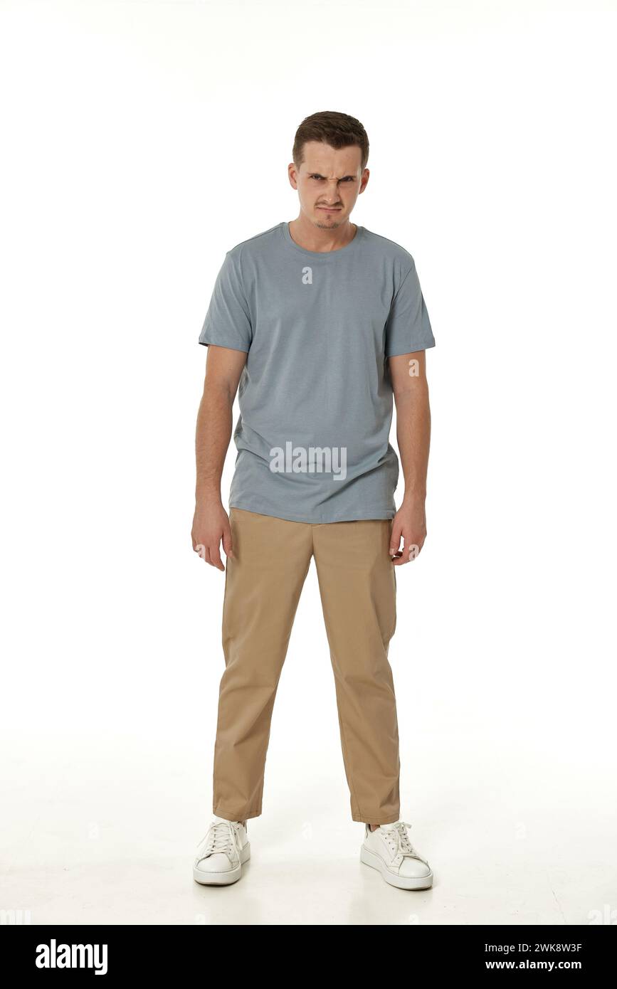 annoyed angry man standing on white studio background Stock Photo - Alamy