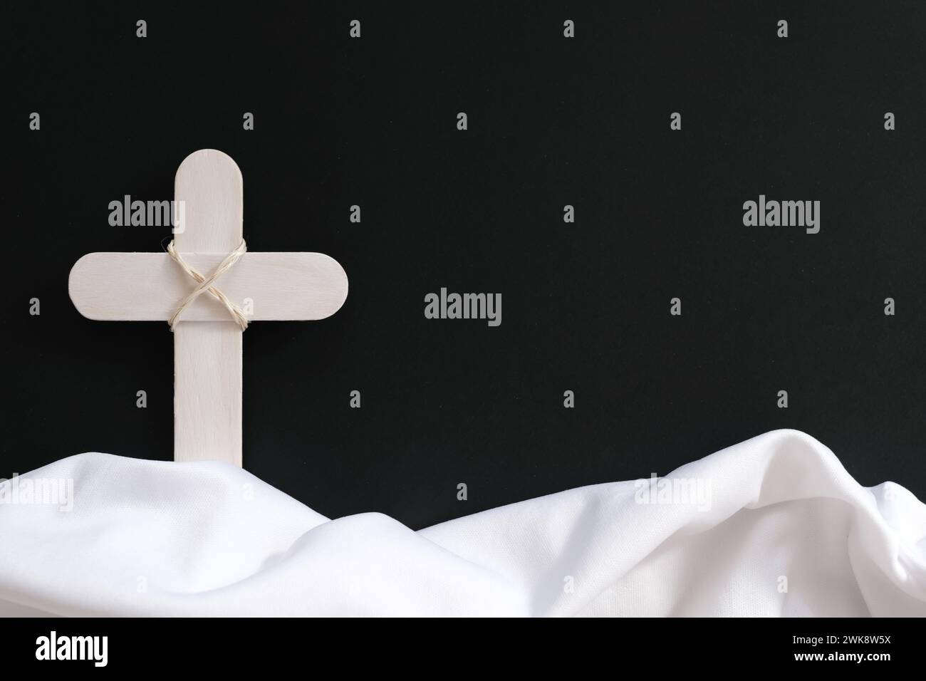 White wooden cross and fabric as symbol of heaven. Funeral and burial ...