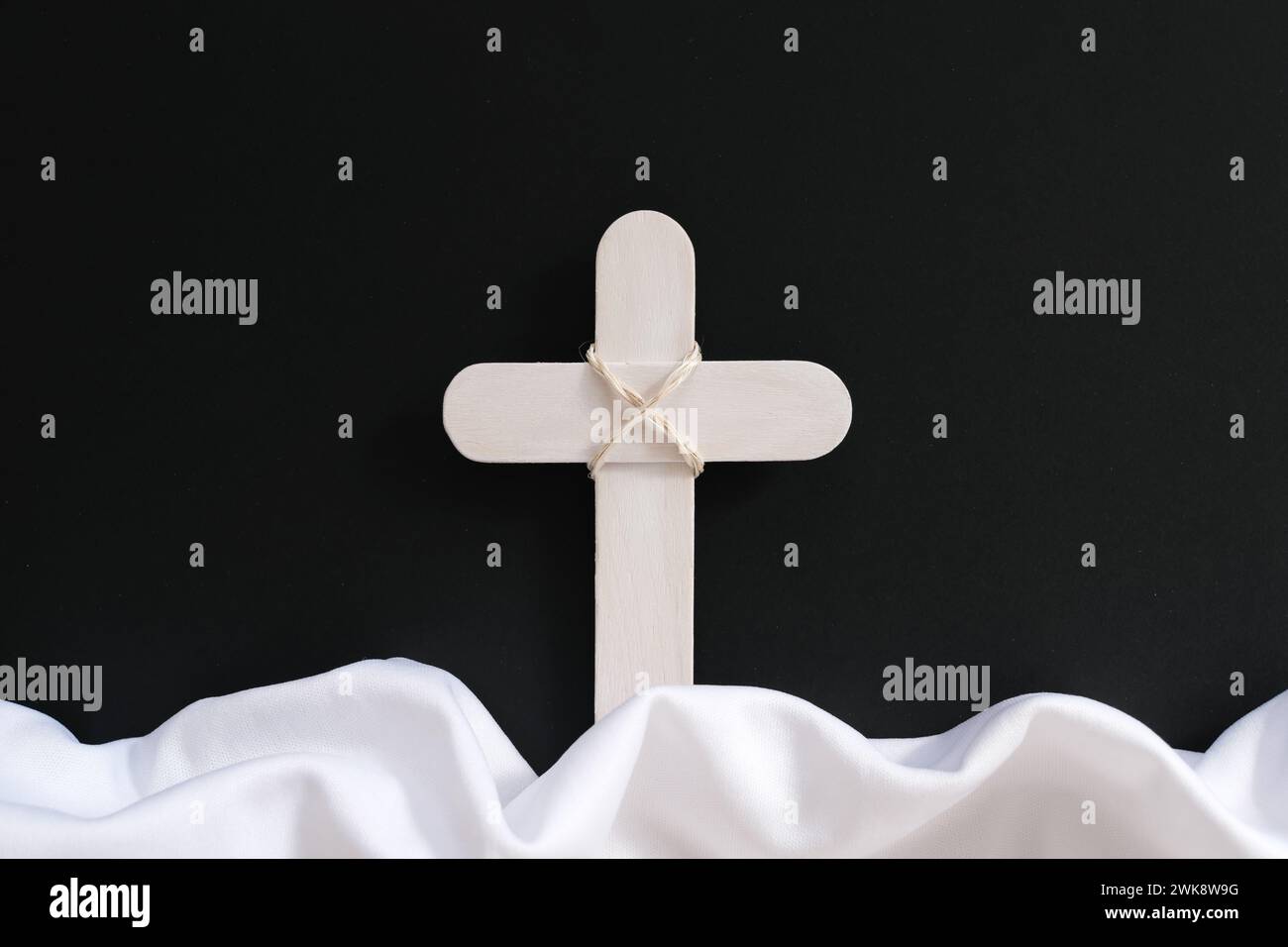 White wooden cross and fabric as symbol of heaven. Funeral and burial ...