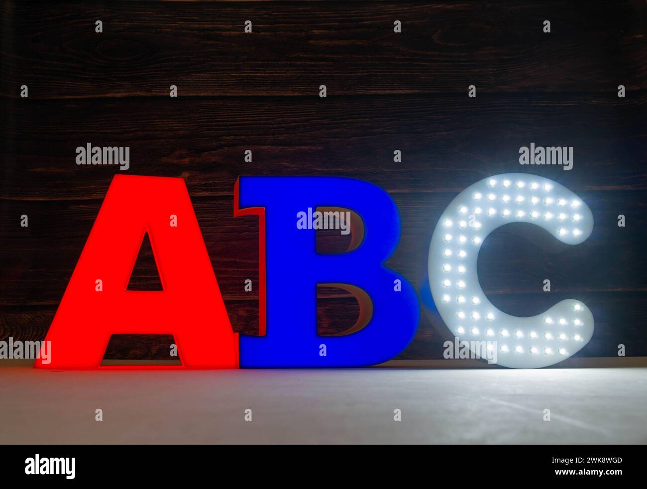 The light letters A, B and C are part of an advertising sign. Red,blue ...
