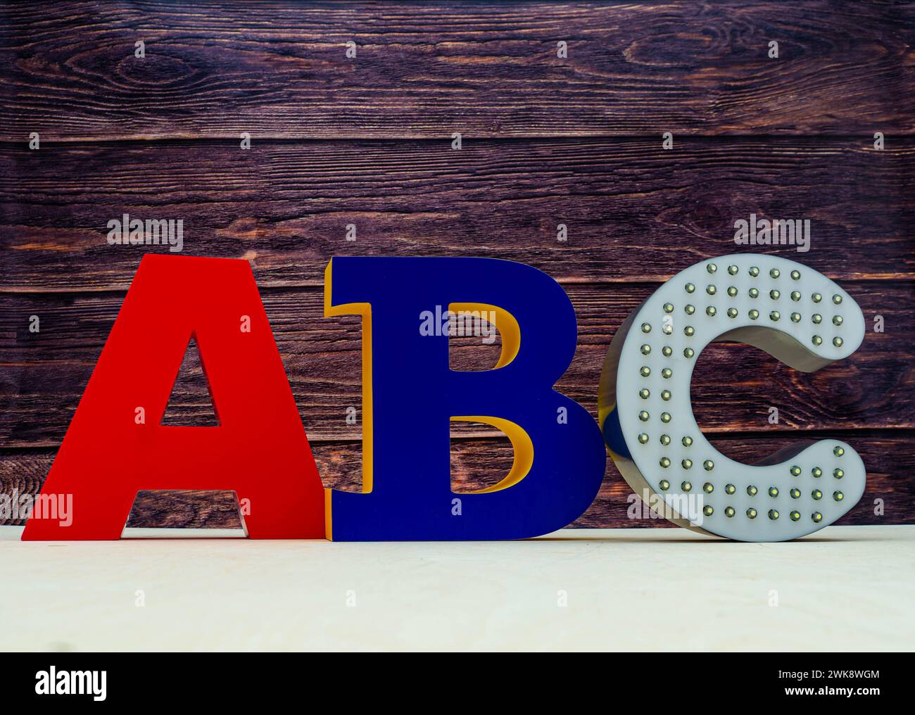 The light letters A, B and C are part of an advertising sign. Red,blue ...