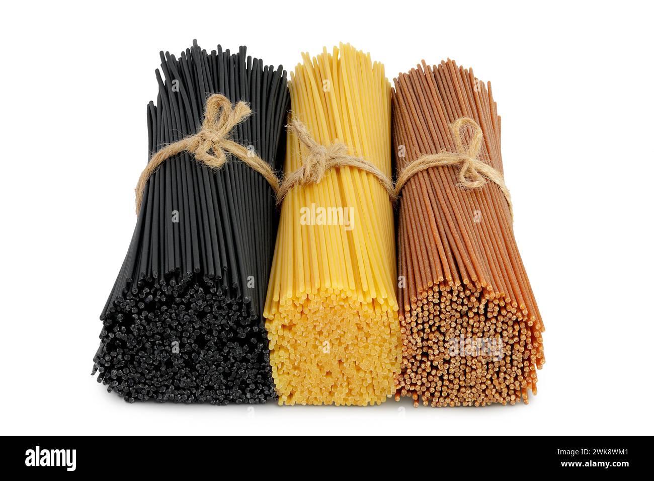 uncooked yellow, black and brown spaghetti isolated on white background ...