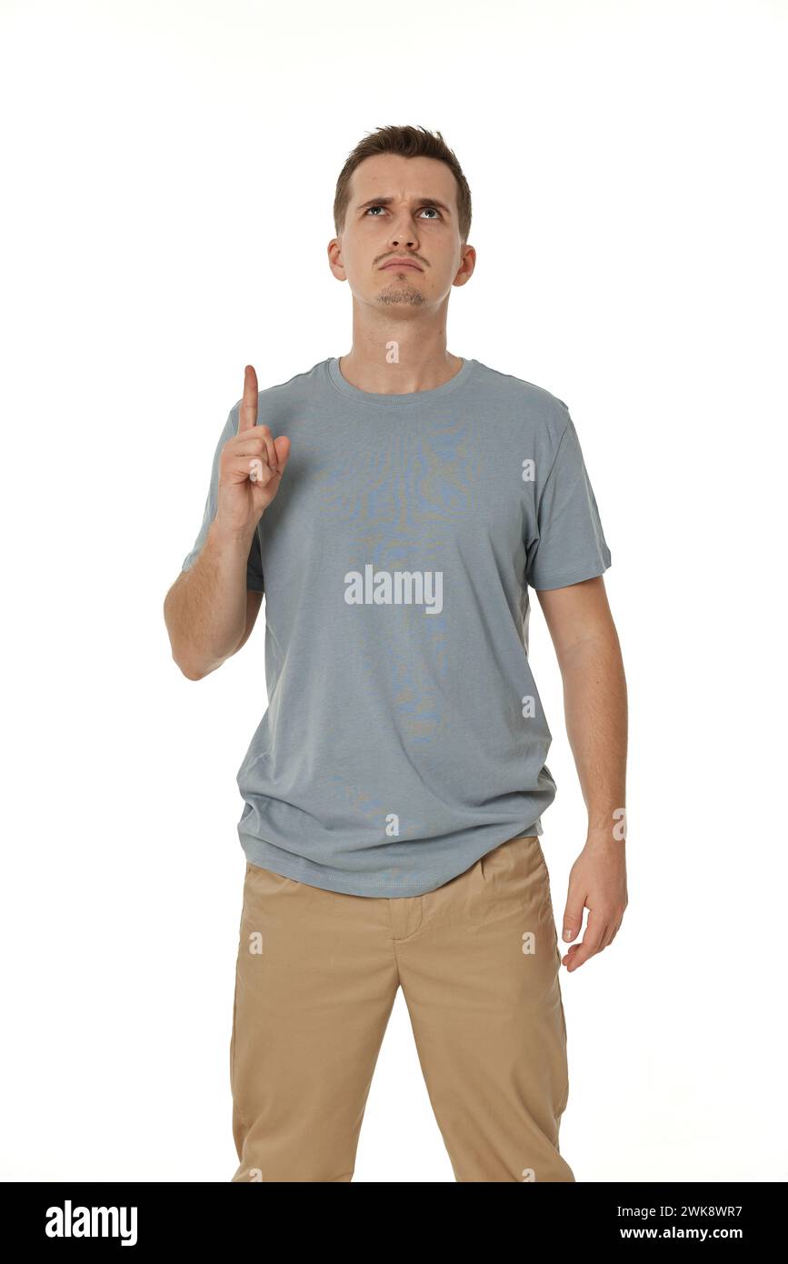 happy guy looking up and pointing up on white studio background Stock ...