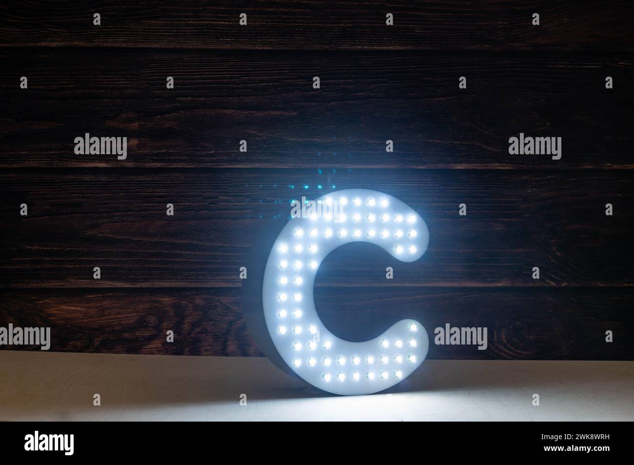 The light letter C is part of an advertising sign. White color Stock ...