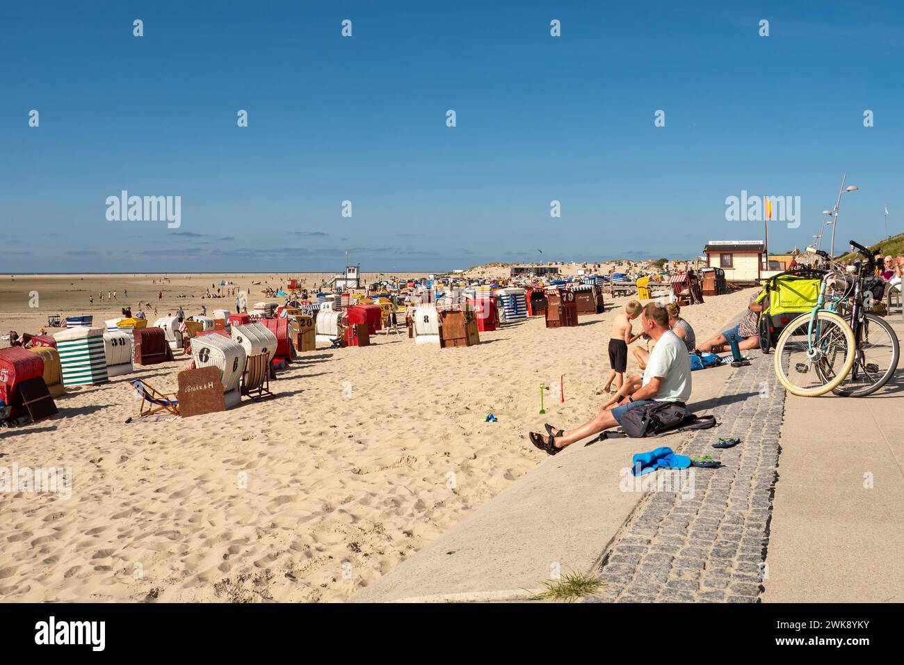 People sitting and relaxing on beach promenade of Borkum island, East ...