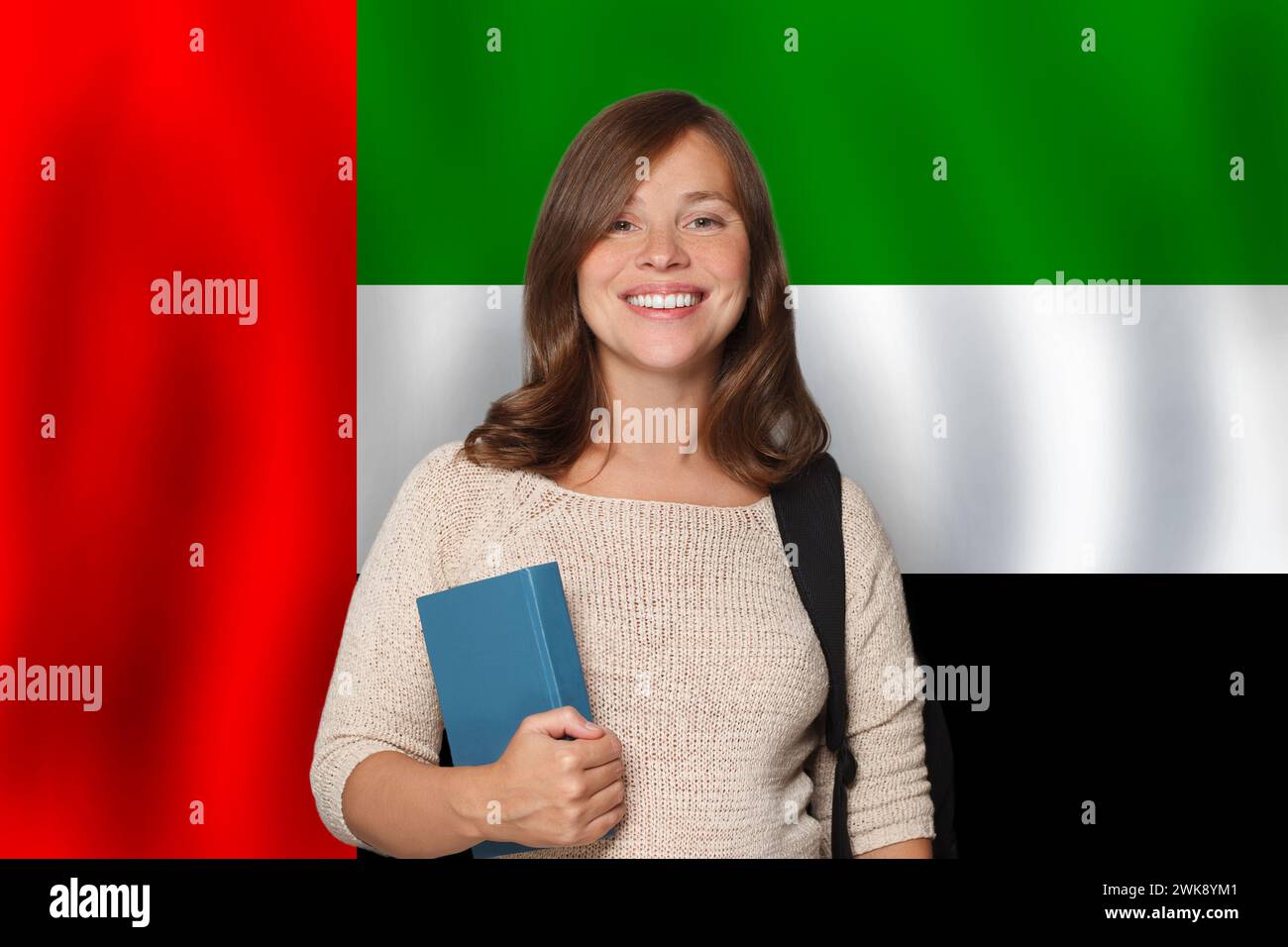 Happy woman student against flag of United Arab Emirates background ...