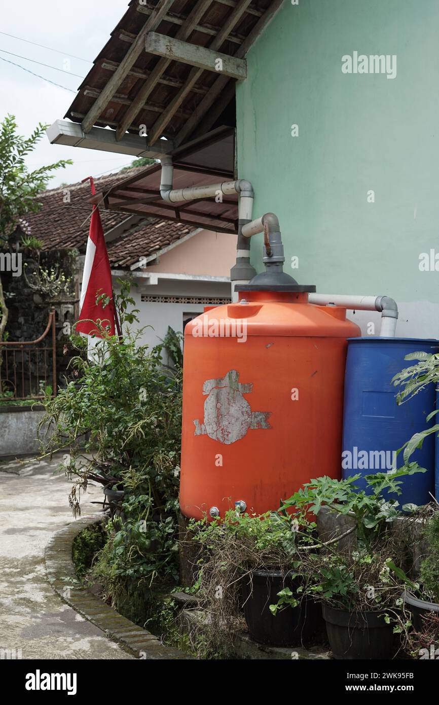 Rainwater storage tank installed outside the house Stock Photo - Alamy