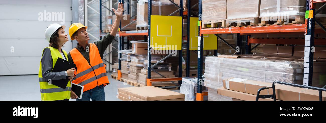 banner of happy supervisor pointing out details to female employee in a ...