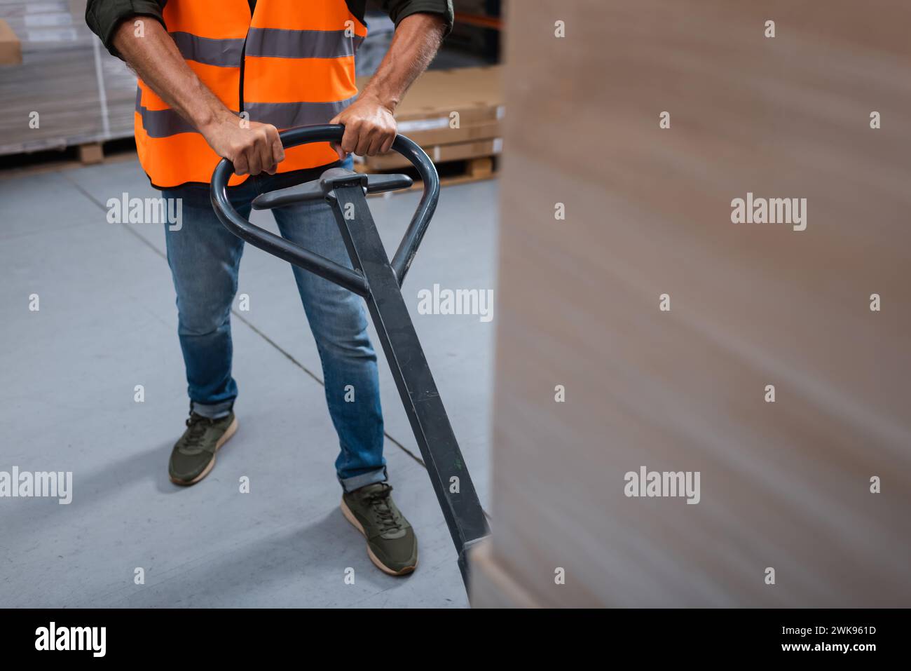 cropped photo of warehouse worker in hard hat and safety vest ...