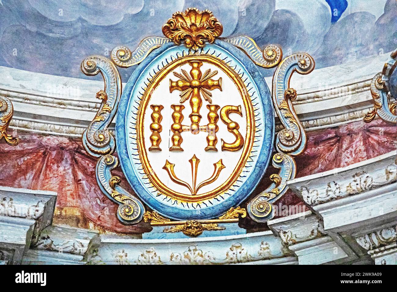 architectural gilded volumetric composition of the initials of Jesus ...