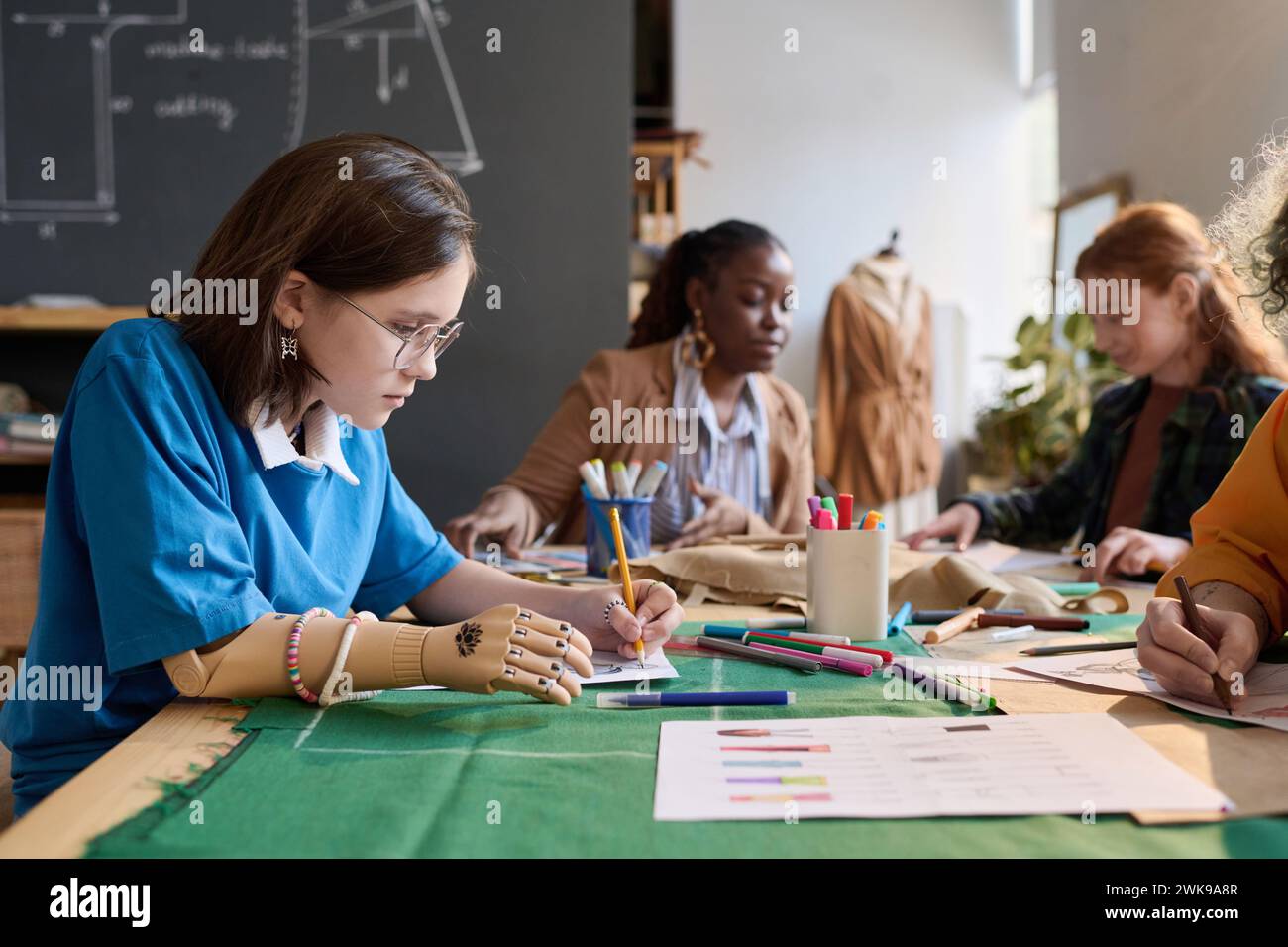 Side view portrait of teenage girl with prosthetic hand drawing ...