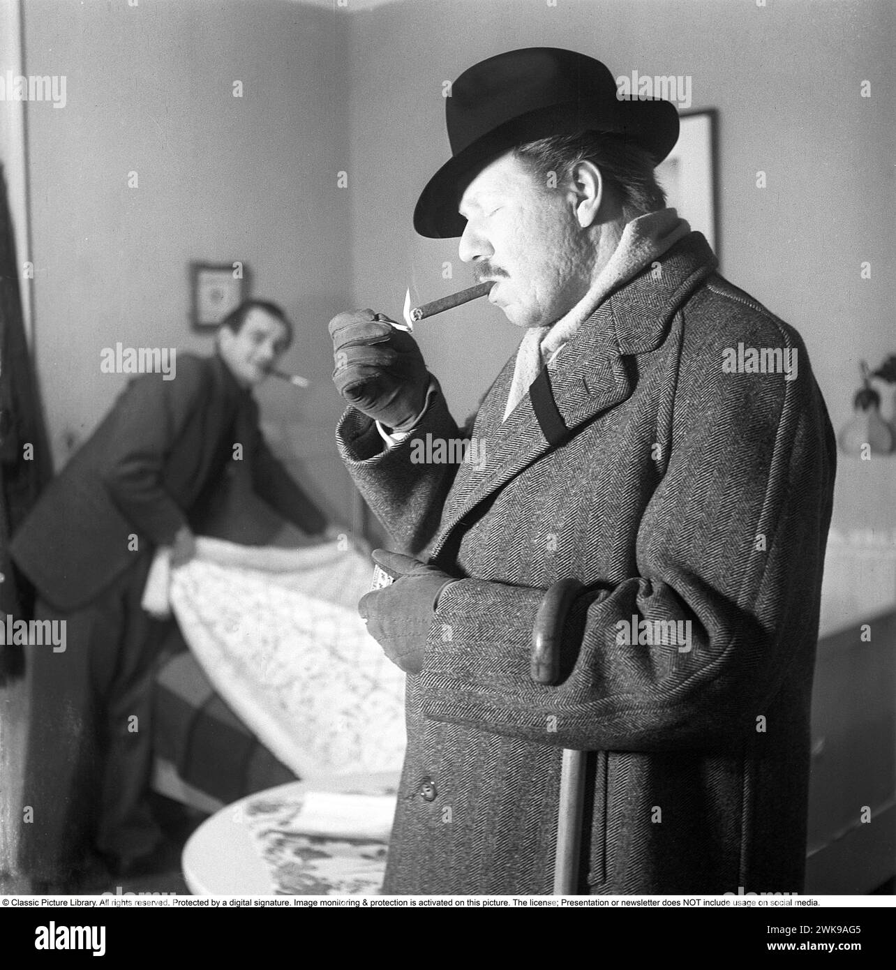 Smoking a cigar 1949. The actor Åke Fridell lights a cigar. Note the ...