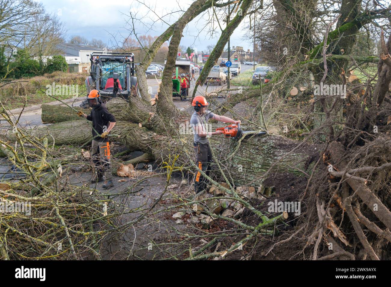 Workers clear a tree that fell and blocked the A417 at the A435 ...