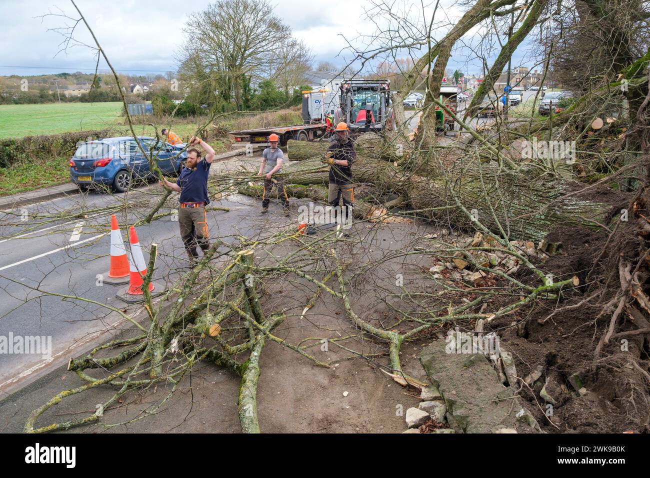 Workers clear a tree that fell and blocked the A417 at the A435 ...